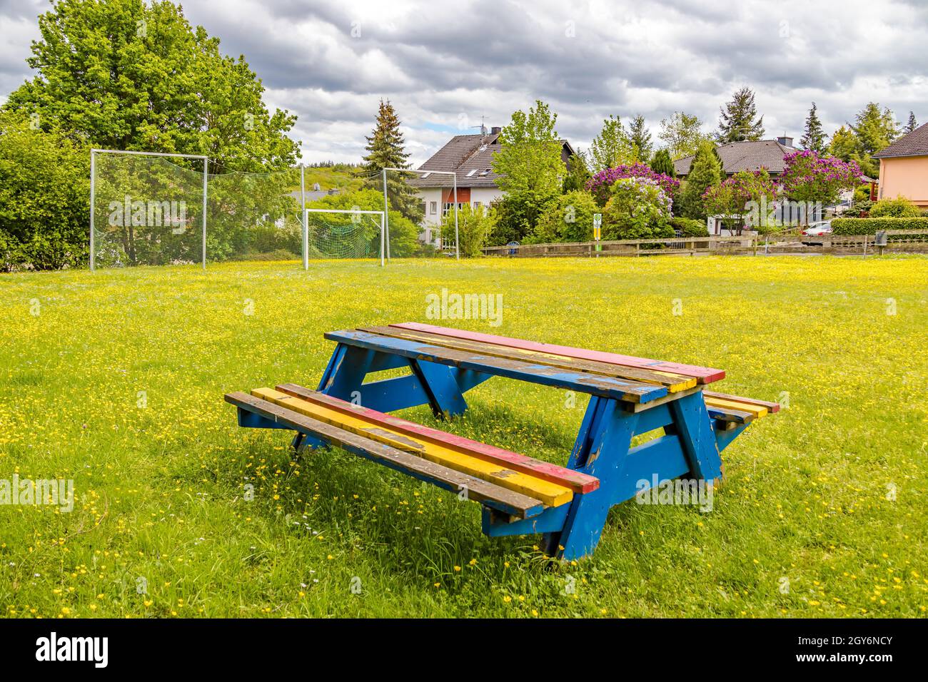 Outdoor bench with wooden table on a green meadow Stock Photo - Alamy
