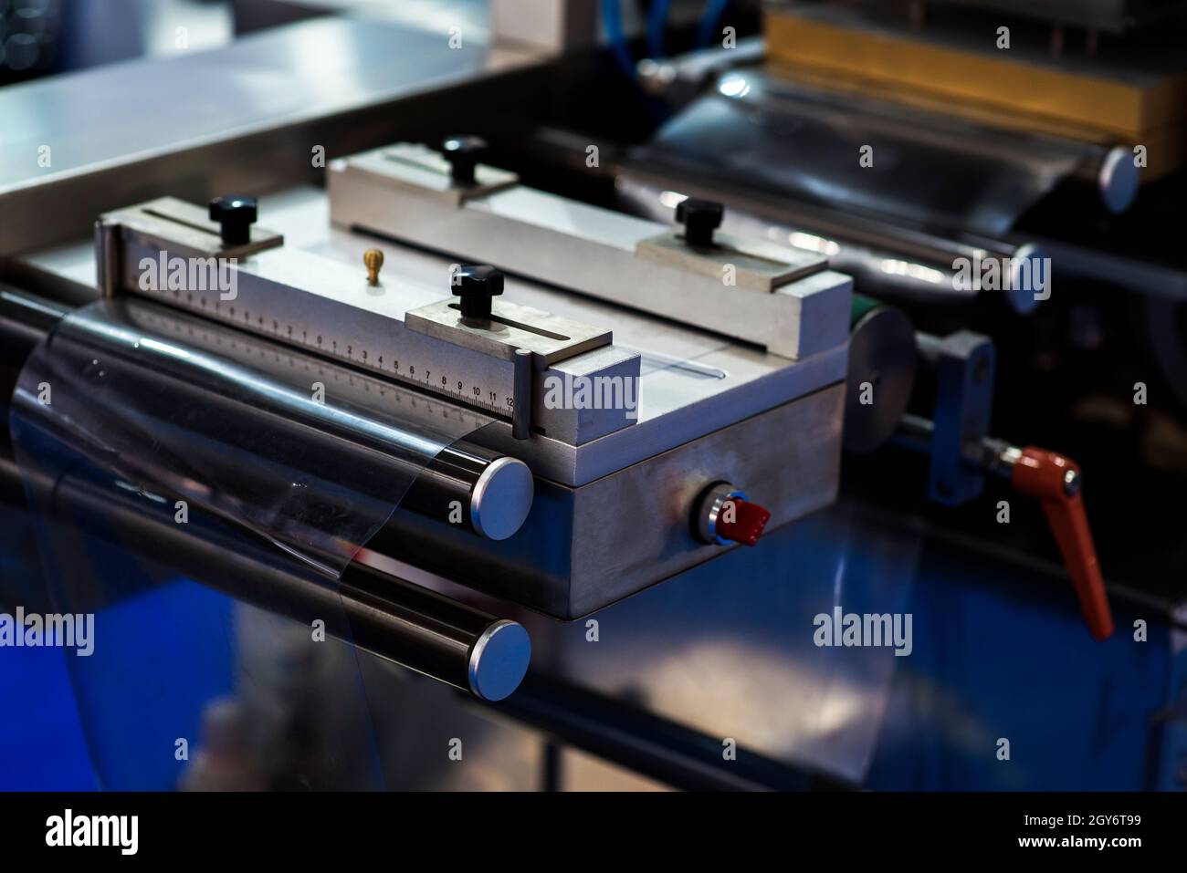 Rotary die cutting machine with slitting blade system Stock Photo - Alamy