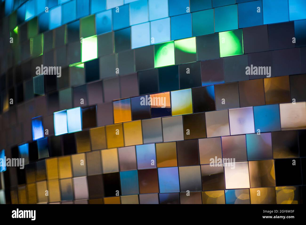 Colorful square metallic tiles on a wall or floor. Blue, green, teal ...