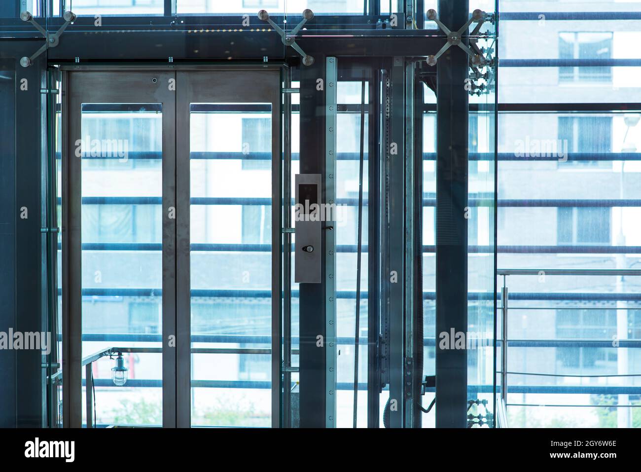 Glass elevator ,Businessman taking modern glass elevator to the upper ...