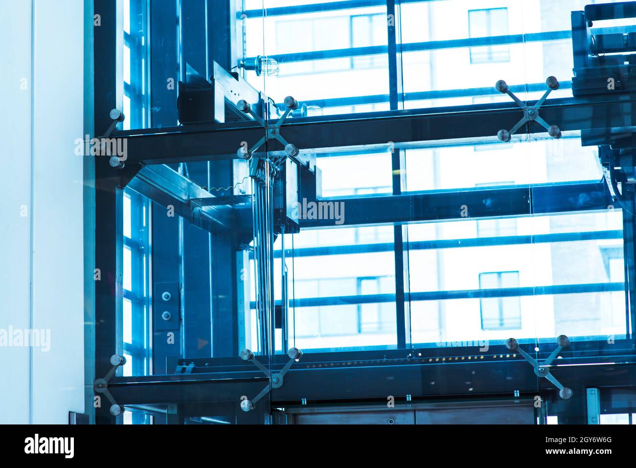Glass elevator ,Businessman taking modern glass elevator to the upper ...
