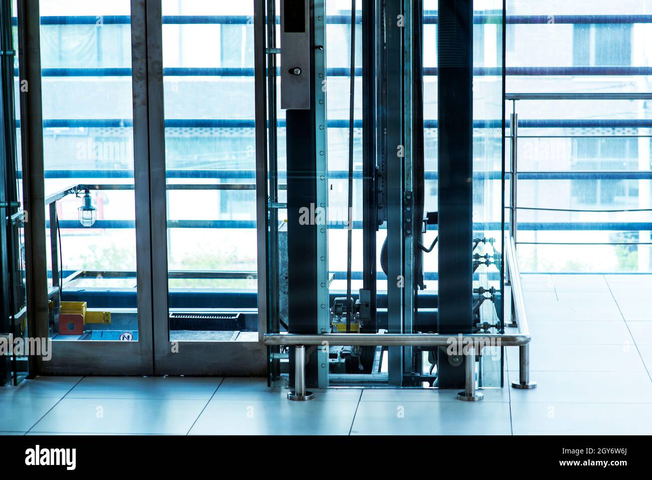 Glass elevator ,Businessman taking modern glass elevator to the upper ...
