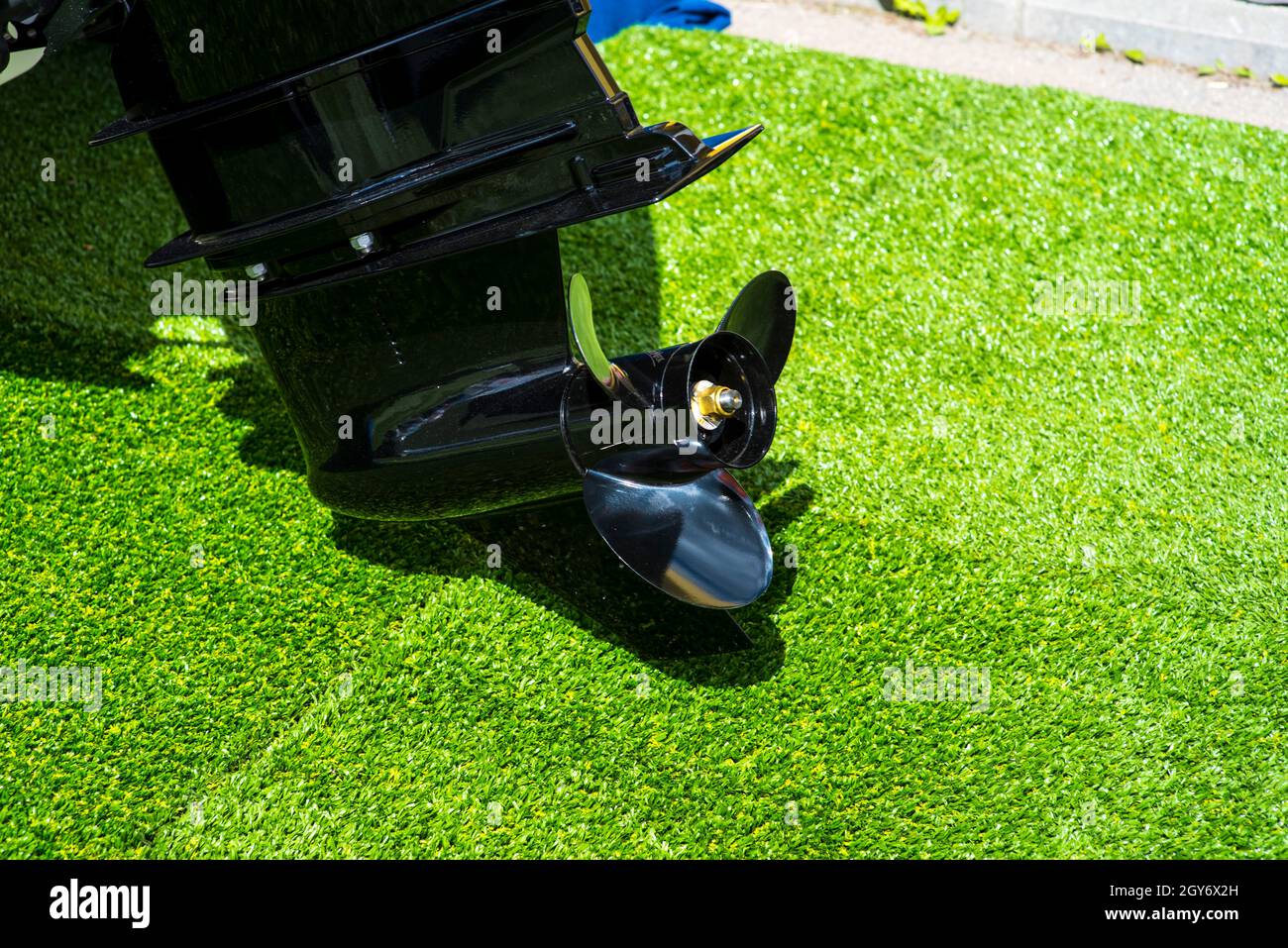 Side view of a new black motor boat engine without cowling on a blurred ...