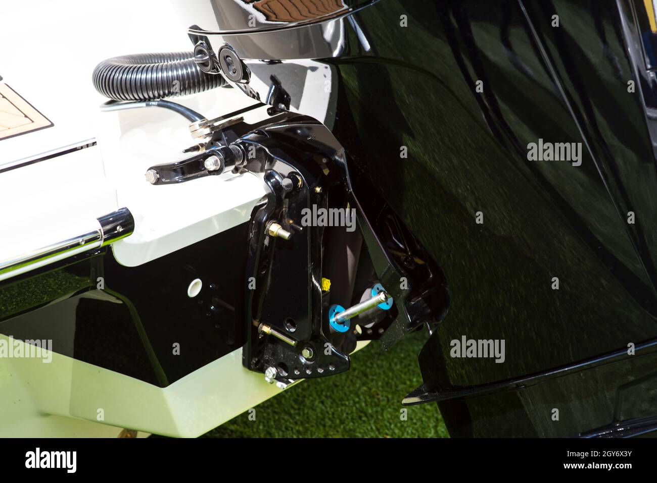 Side view of a new black motor boat engine without cowling on a blurred ...