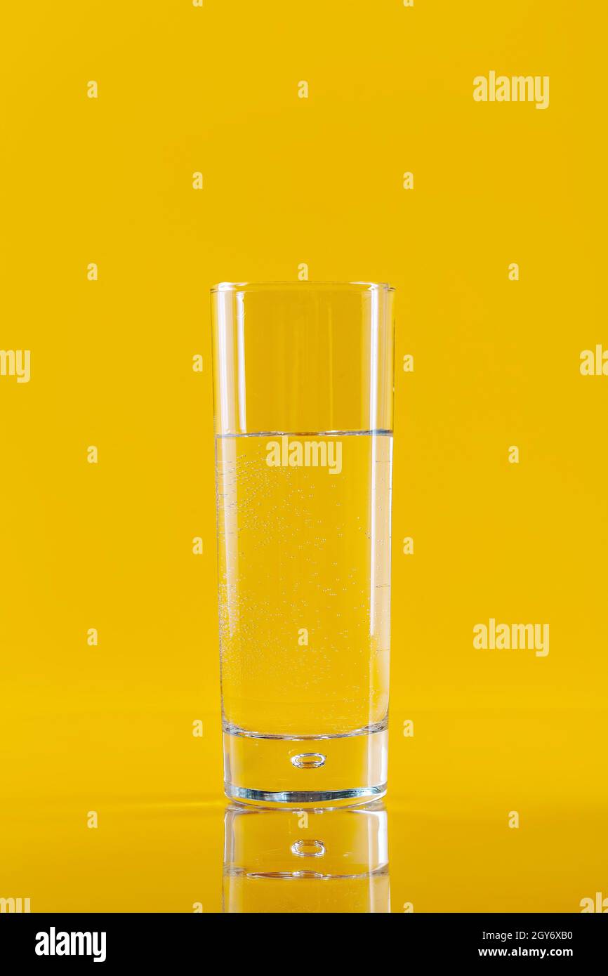 Glass of water on yellow background. Healthy lifestyle Stock Photo - Alamy
