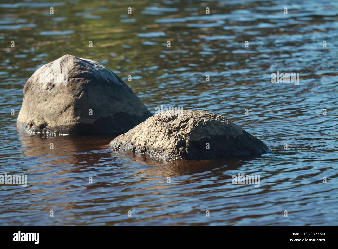 river landscape with granite boulders in blue water Stock Photo - Alamy