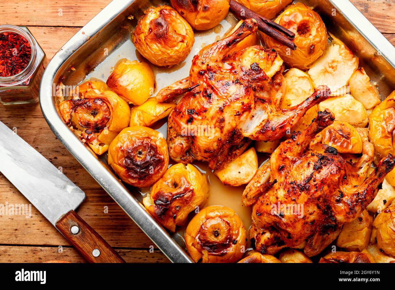 Delicious baked partridge with apples in an iron tray Stock Photo - Alamy