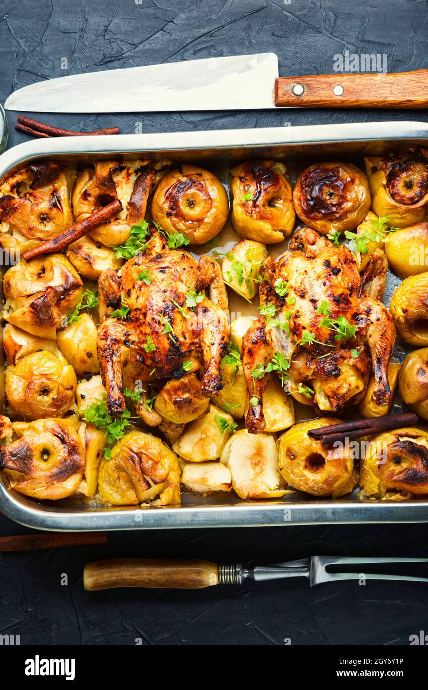 Delicious baked partridge with apples in an iron tray Stock Photo - Alamy