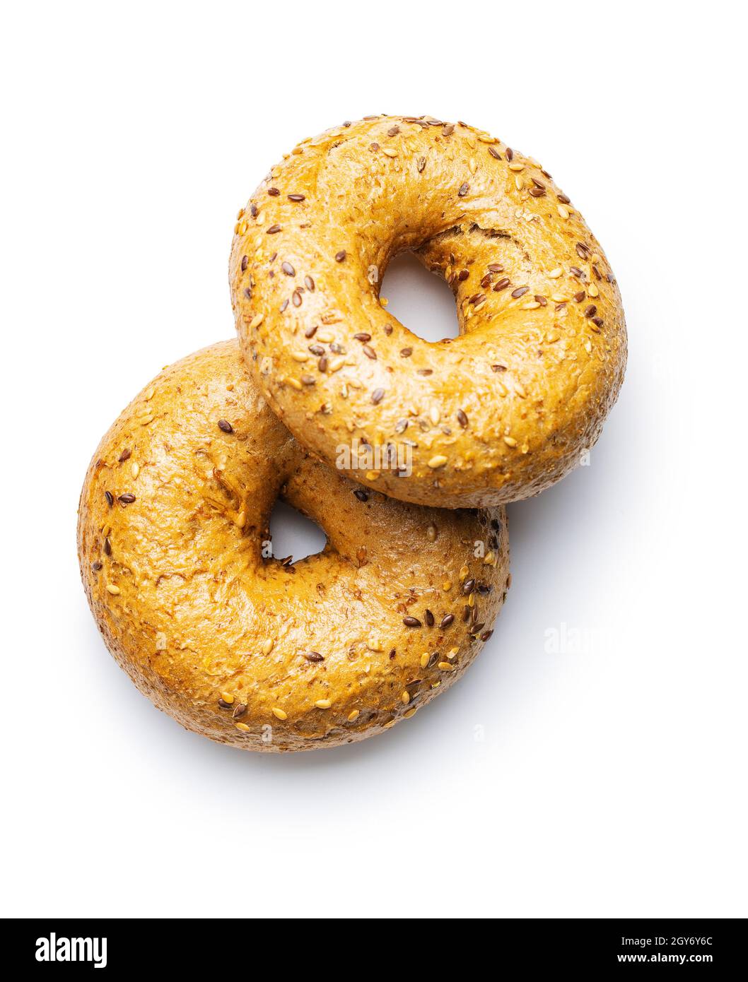 Whole grain baked bagel isolated on white background Stock Photo - Alamy