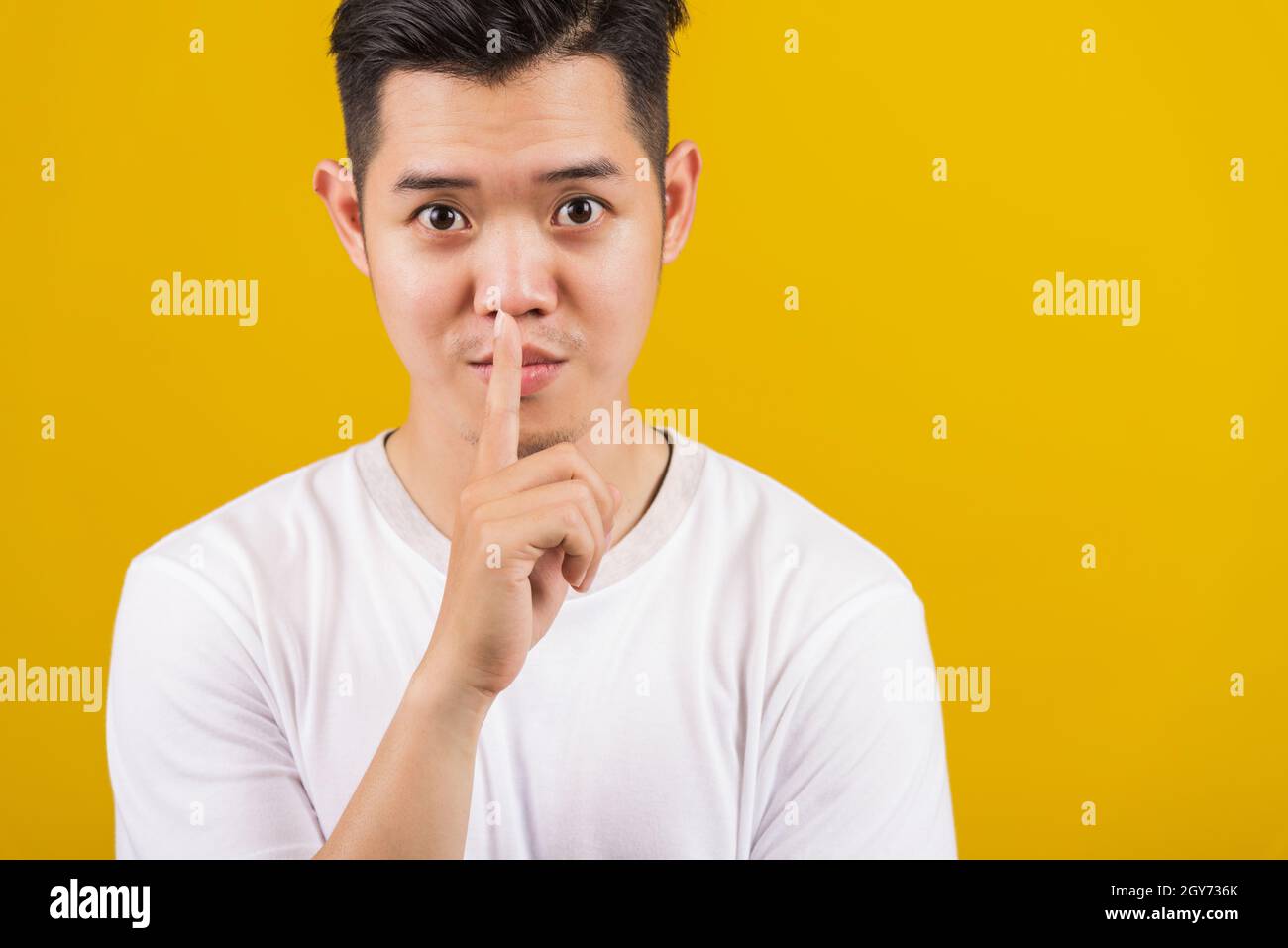 Face one finger over mouth hi-res stock photography and images - Alamy