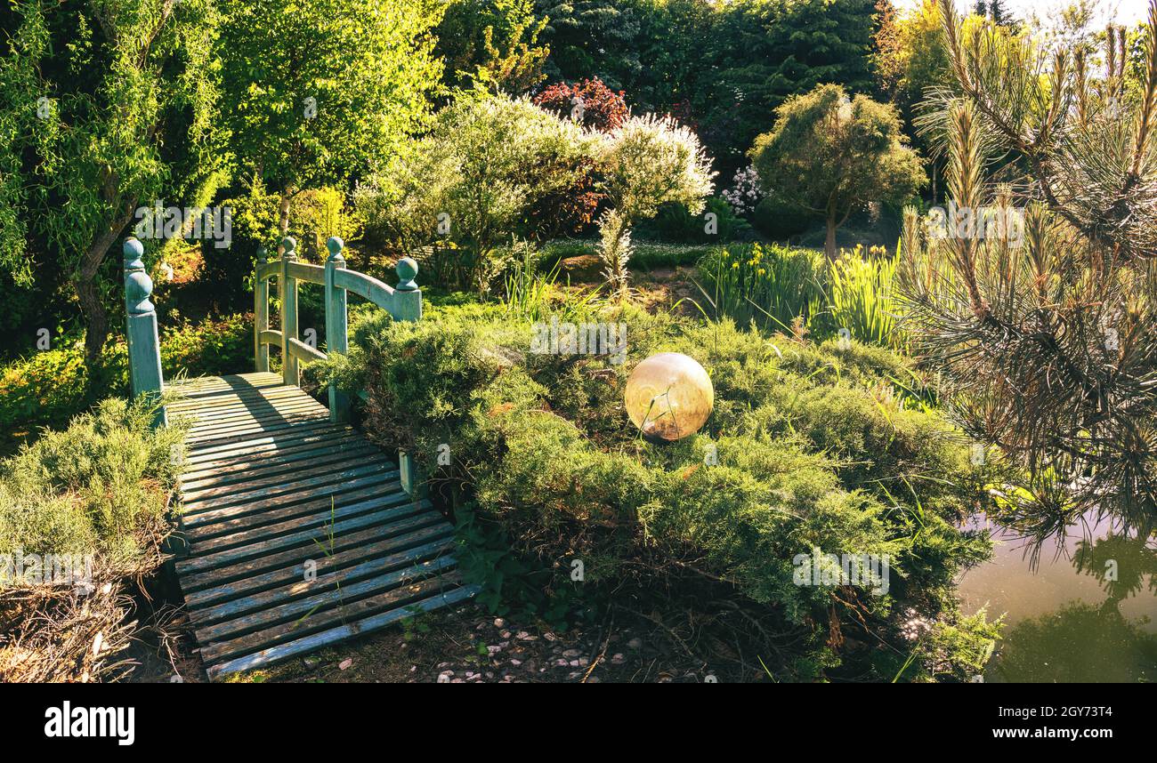 Wooden footbridge over a garden pond hi-res stock photography and ...