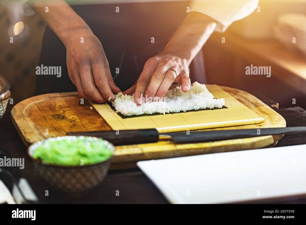 Chef making Japanese sushi rolls. Process of making sushi Stock Photo ...