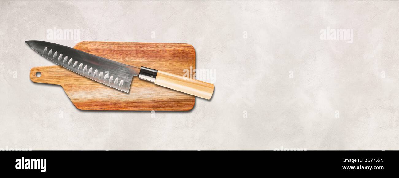 Traditional Japanese gyuto chief knife on a cutting board. White ...