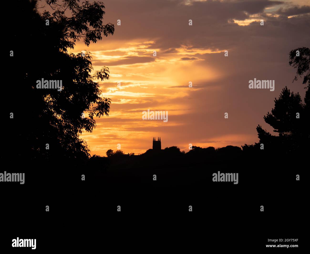 English evening sunset. Church in distance, rural setting Stock Photo ...