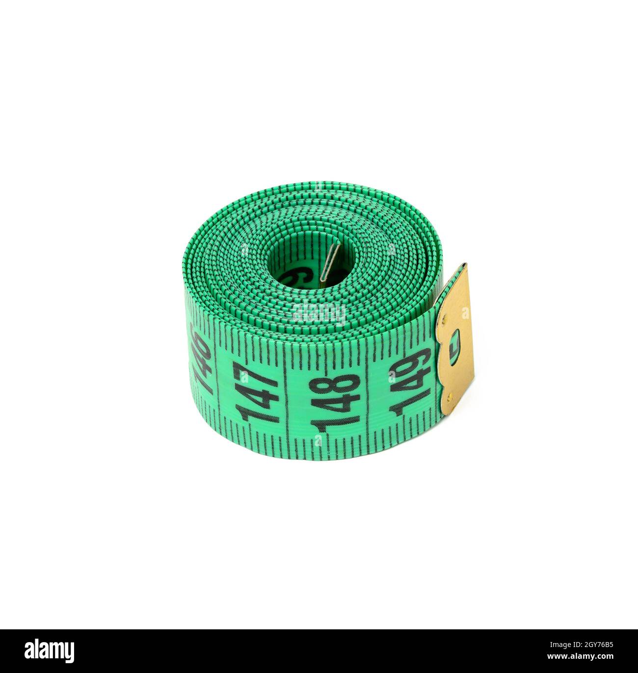 twisted green measuring tape on a white background. Tailor item, close ...