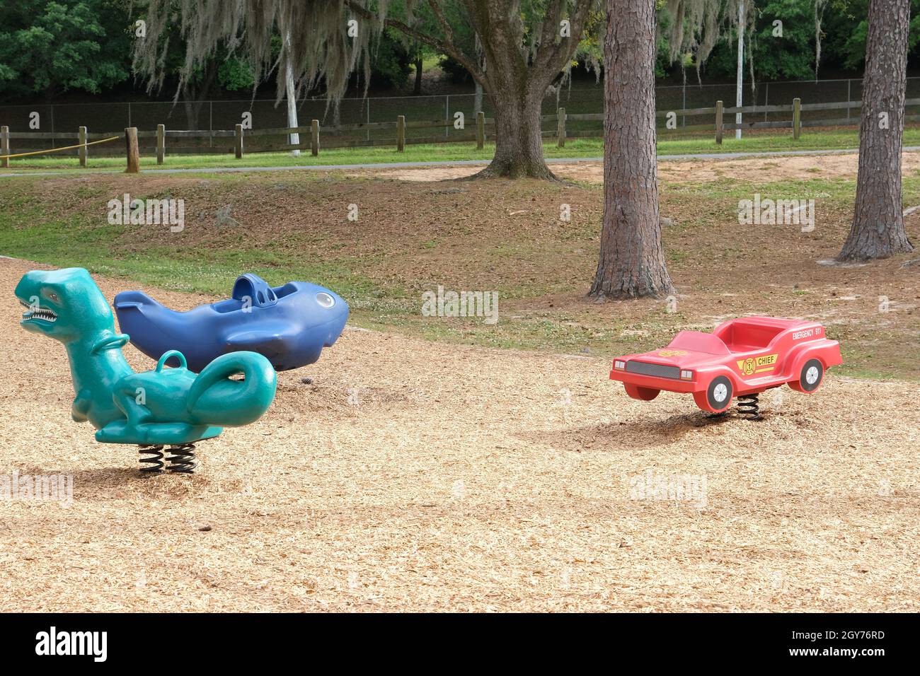 Blue, red and cyan spring riders in a mulch park in Tallahassee Tom ...