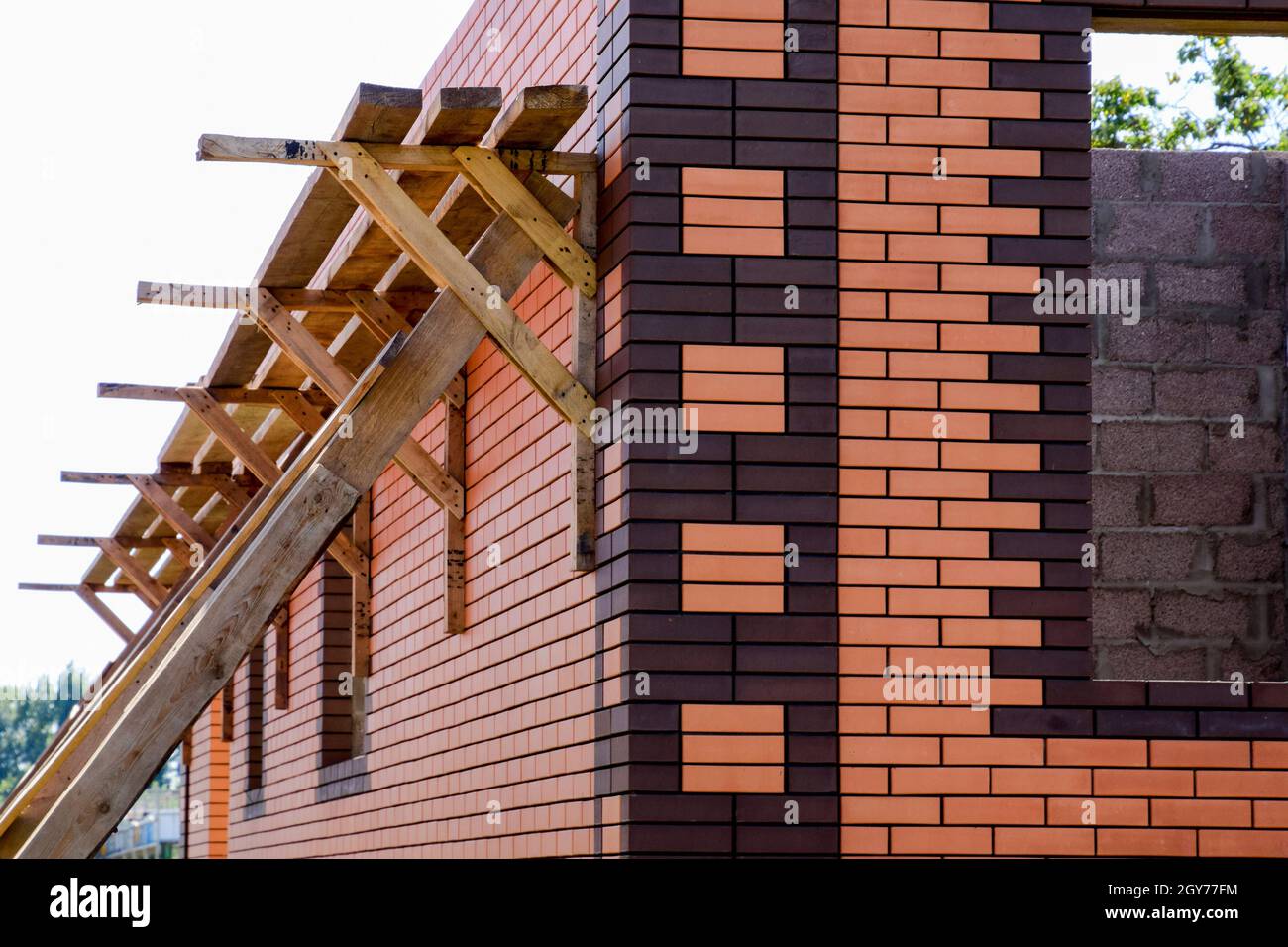 New brick house under construction. Brown and pink brick Stock Photo ...