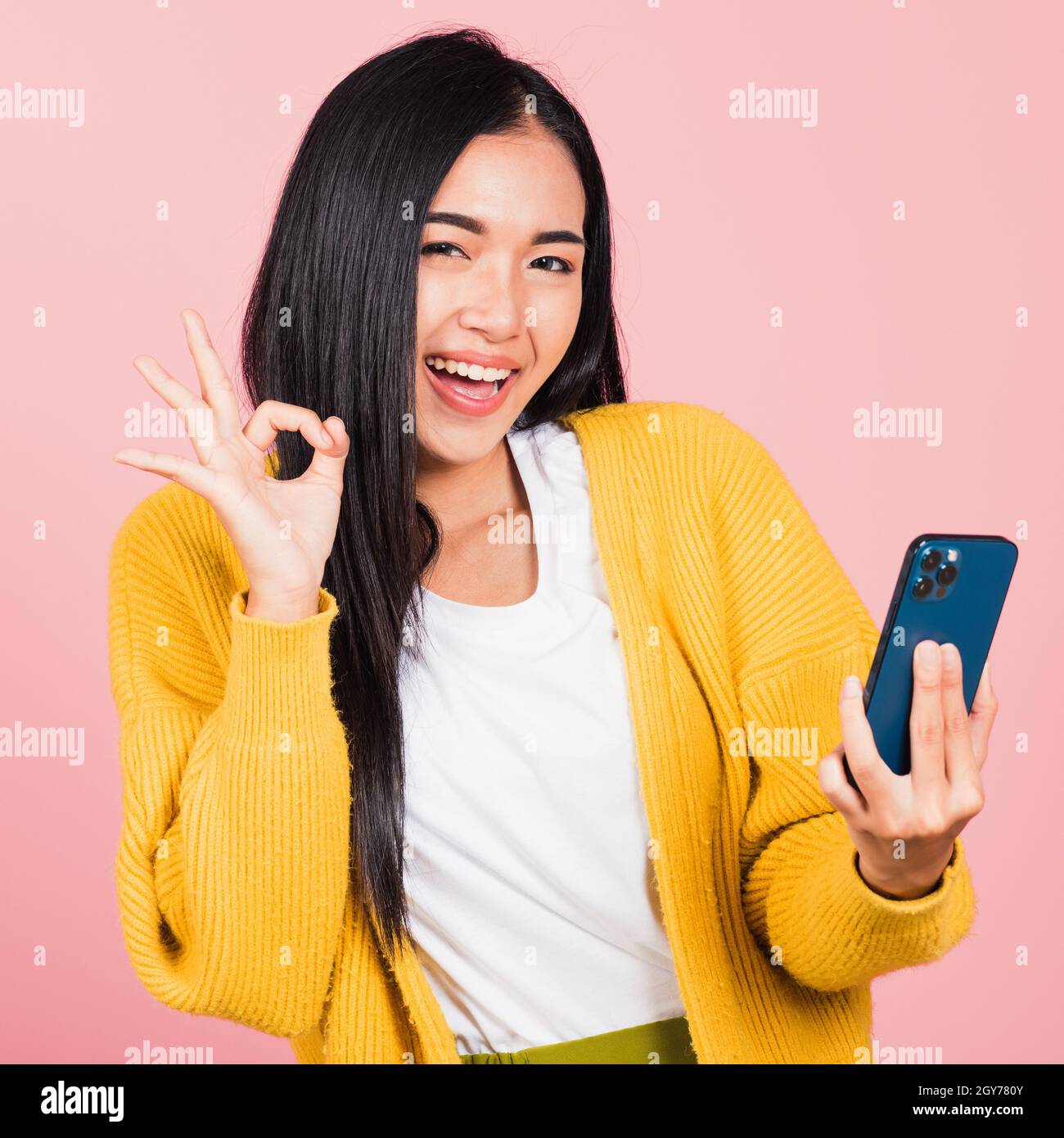 Happy Asian portrait beautiful cute young woman excited holding mobile ...