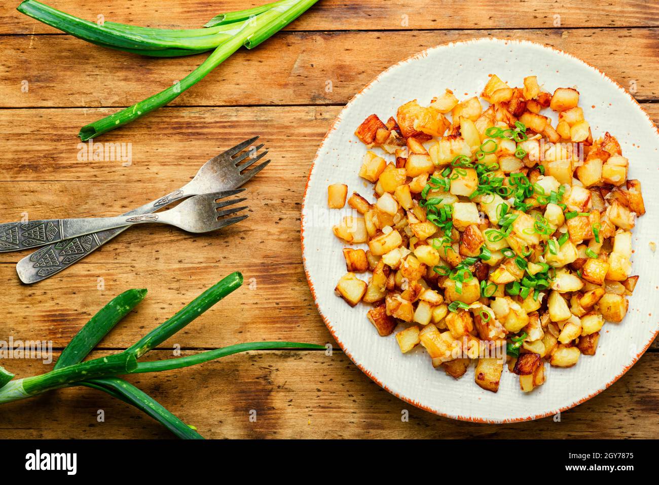 Appetizing fried potatoes.Roasted potatoes on the plate Stock Photo - Alamy