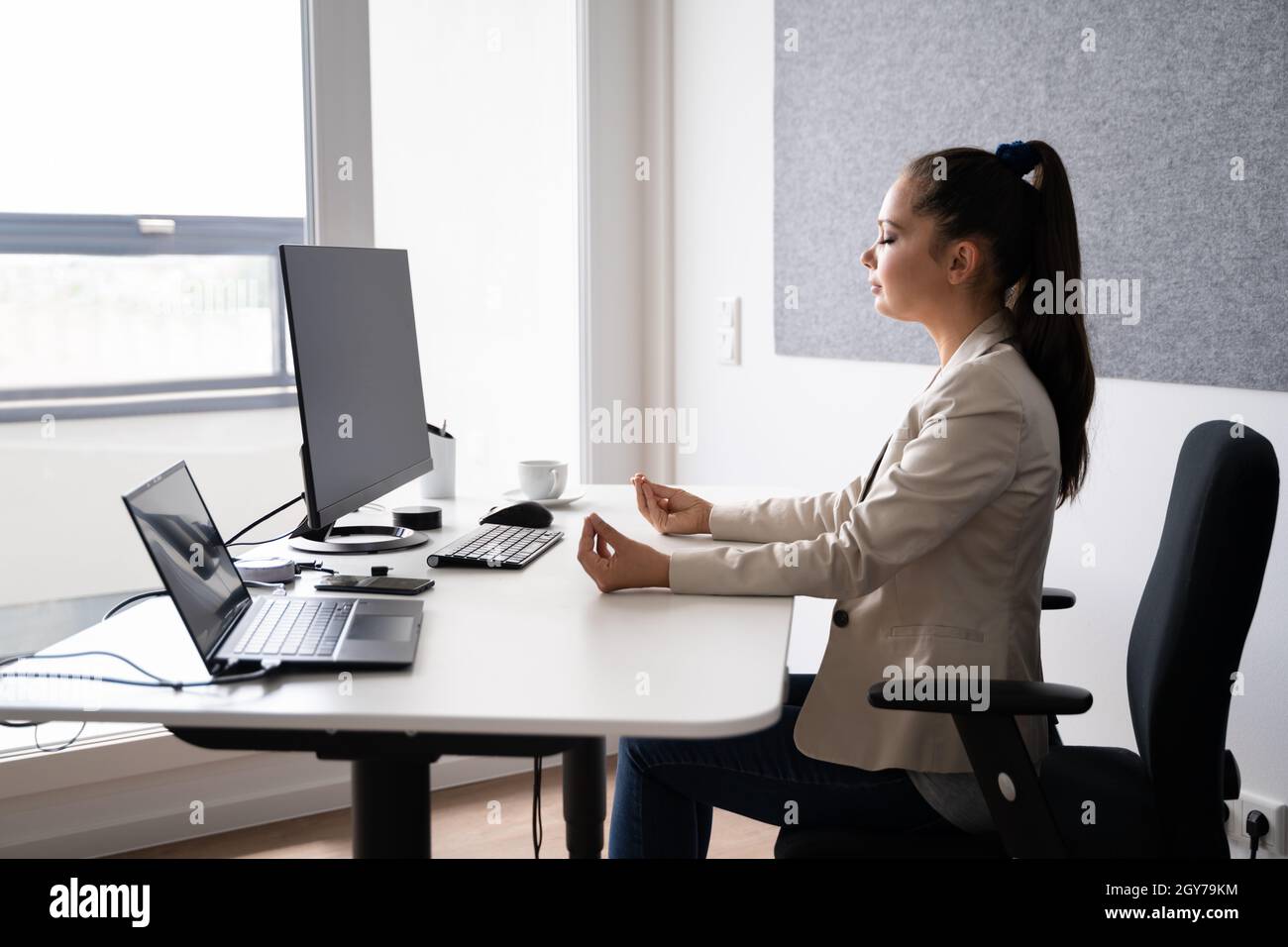 Healthy Yoga Exercise In Office Chair At Workplace Stock Photo - Alamy