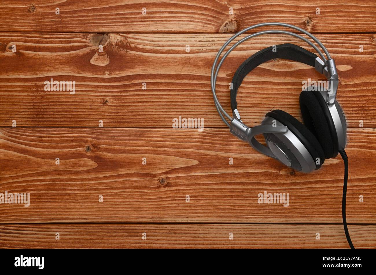 Vintage headphones for listening to sound and music on a brown wooden ...