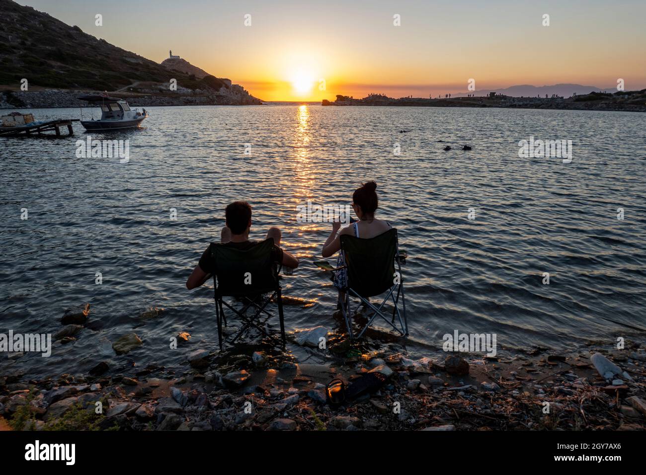 Couple watching sunset in Knidos, Greek city of ancient Caria and part ...