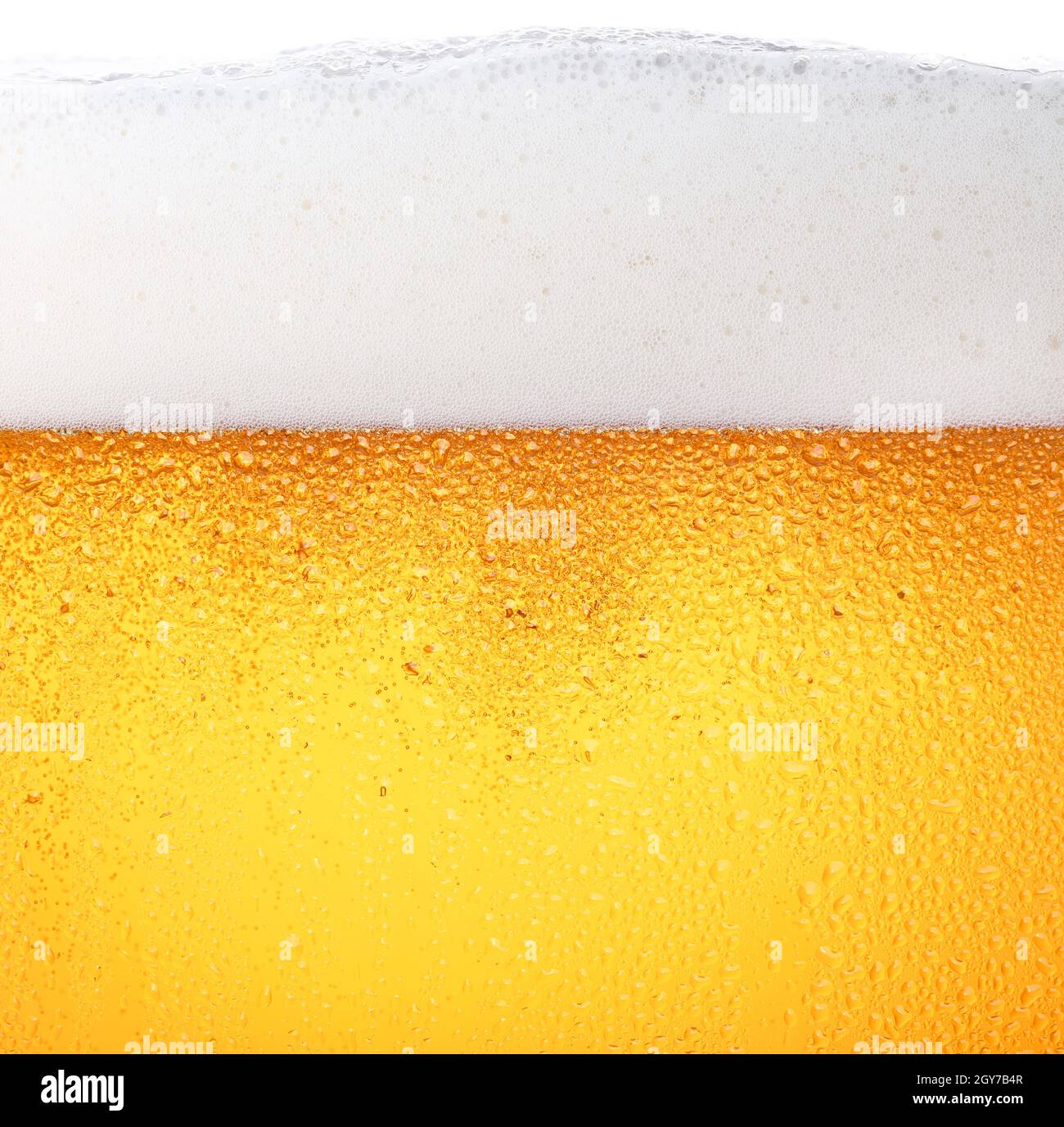 Close up background texture of pouring lager beer with bubbles and ...