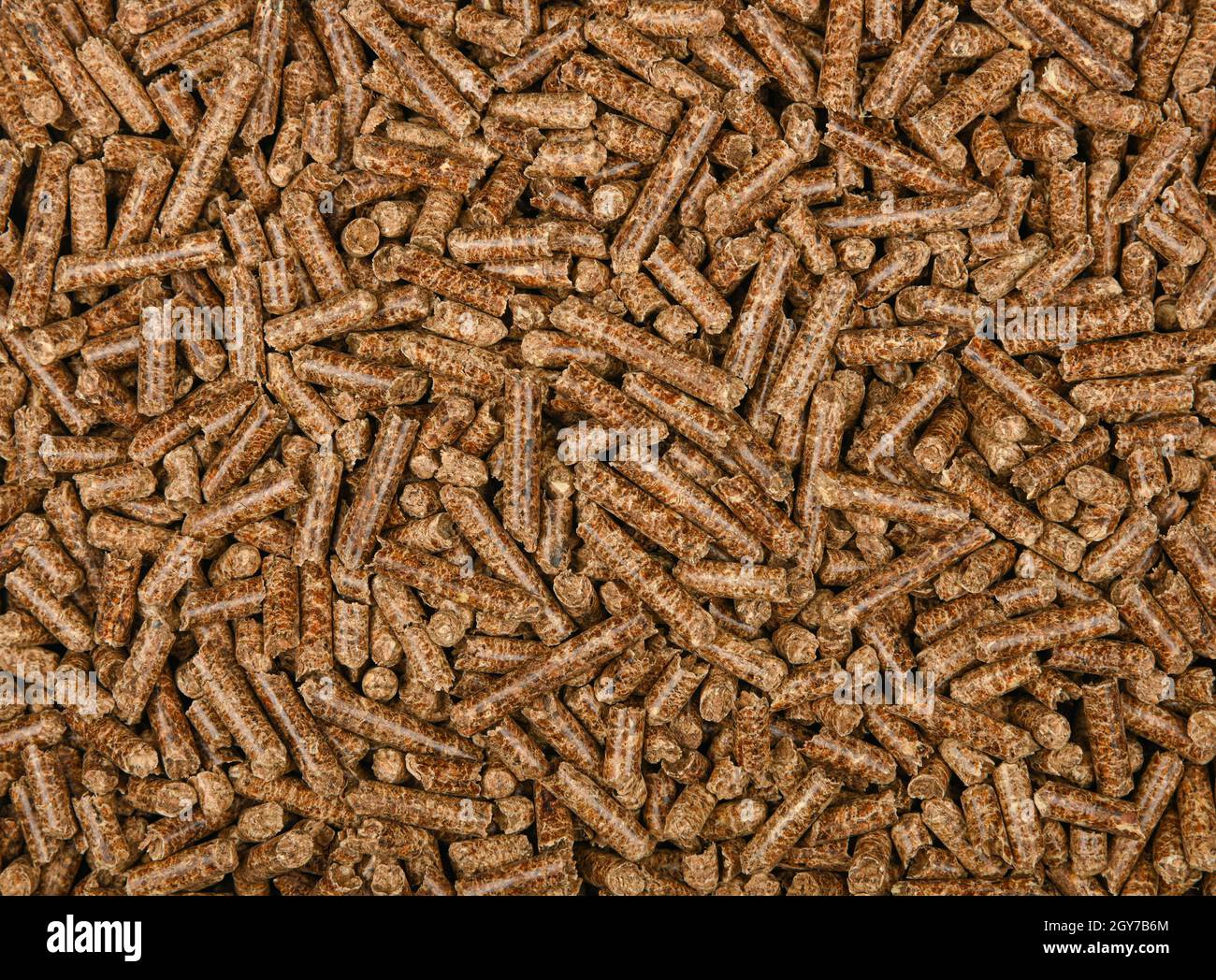 Close up background pattern of hardwood pellets for food smoking and ...