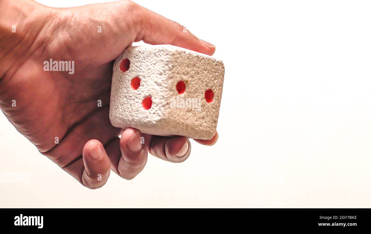 Hand & Rolling Dice. Hand rolls a dices on white isolated background ...