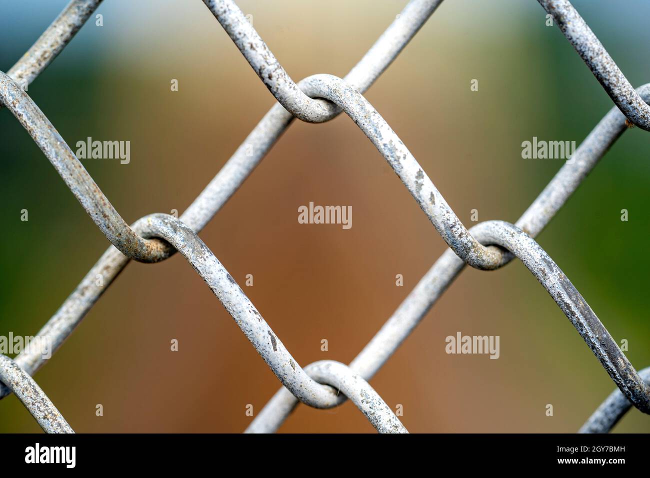 A close up picture of a rusty wire fence with colorful background Stock ...