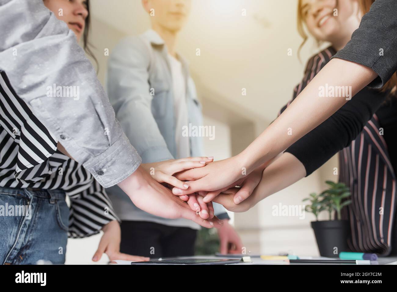 Friendly group of people doing handshake and cross hands. Friendship ...