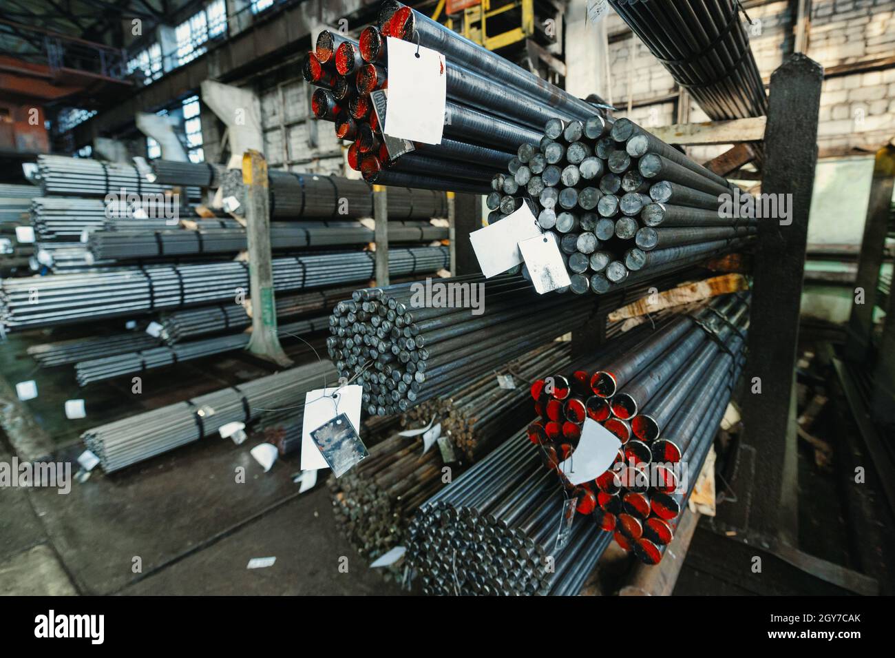 Rolled metal warehouse. Many packs of metal bars on the shelves Stock ...