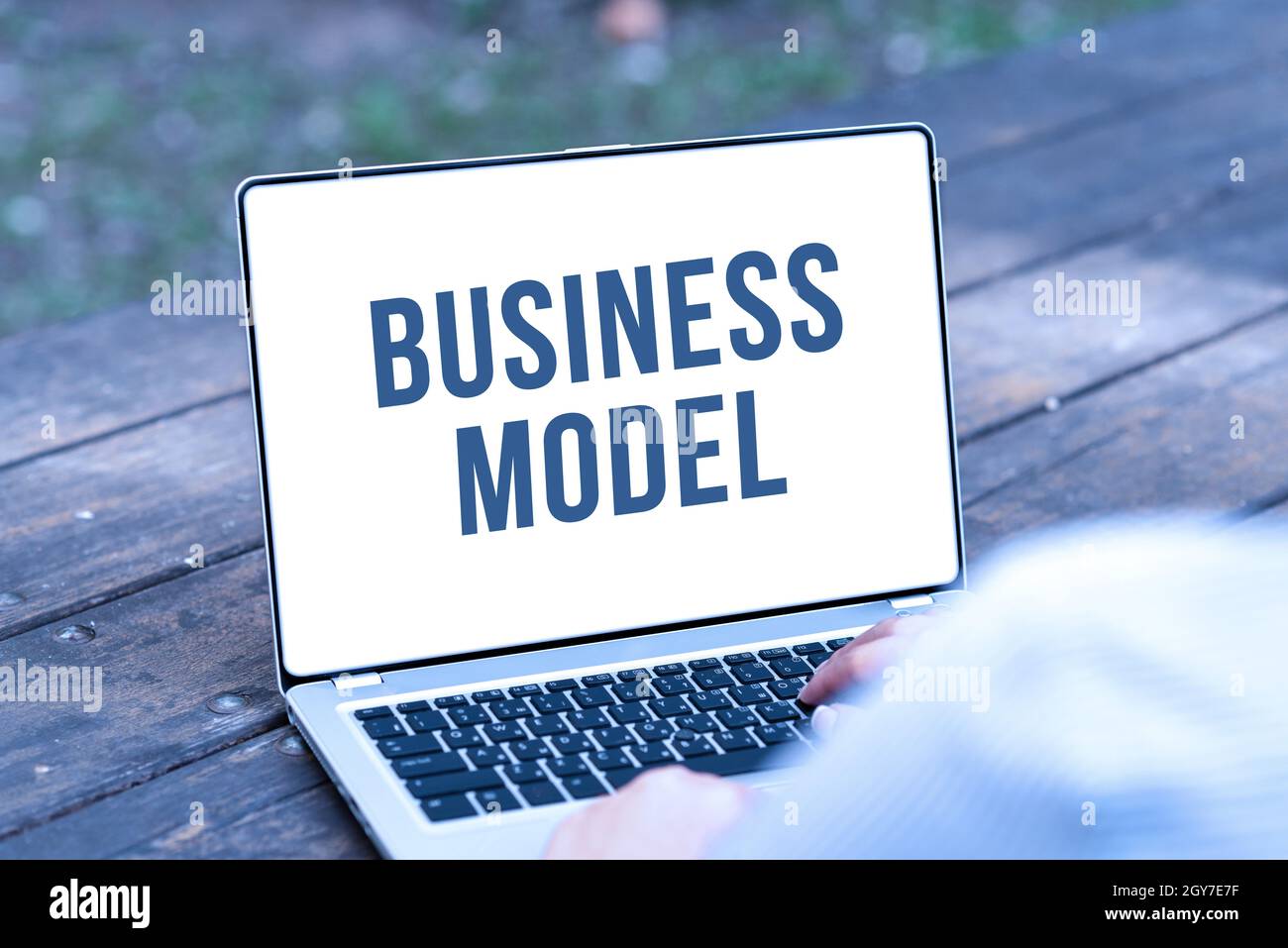 Hand writing sign Business Model, Internet Concept model showing how a ...