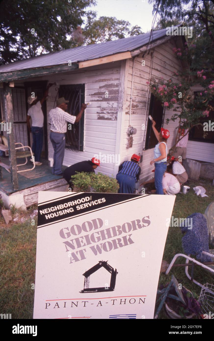 San Antonio Texas USA, May 1991: Volunteers paint a run-down house in a ...
