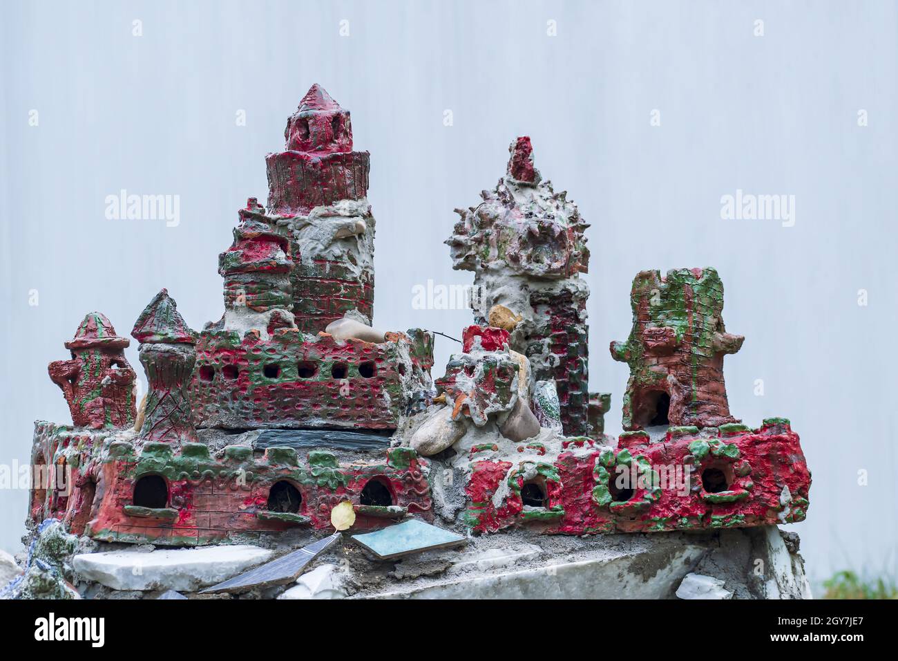 A multi-colored clay model of an old castle on a light blue background ...