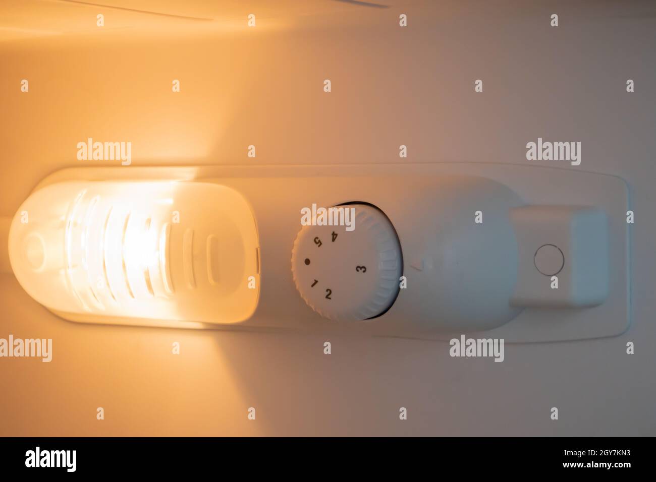 Orange light inside the refrigerator close-up. A lamp that turns on ...