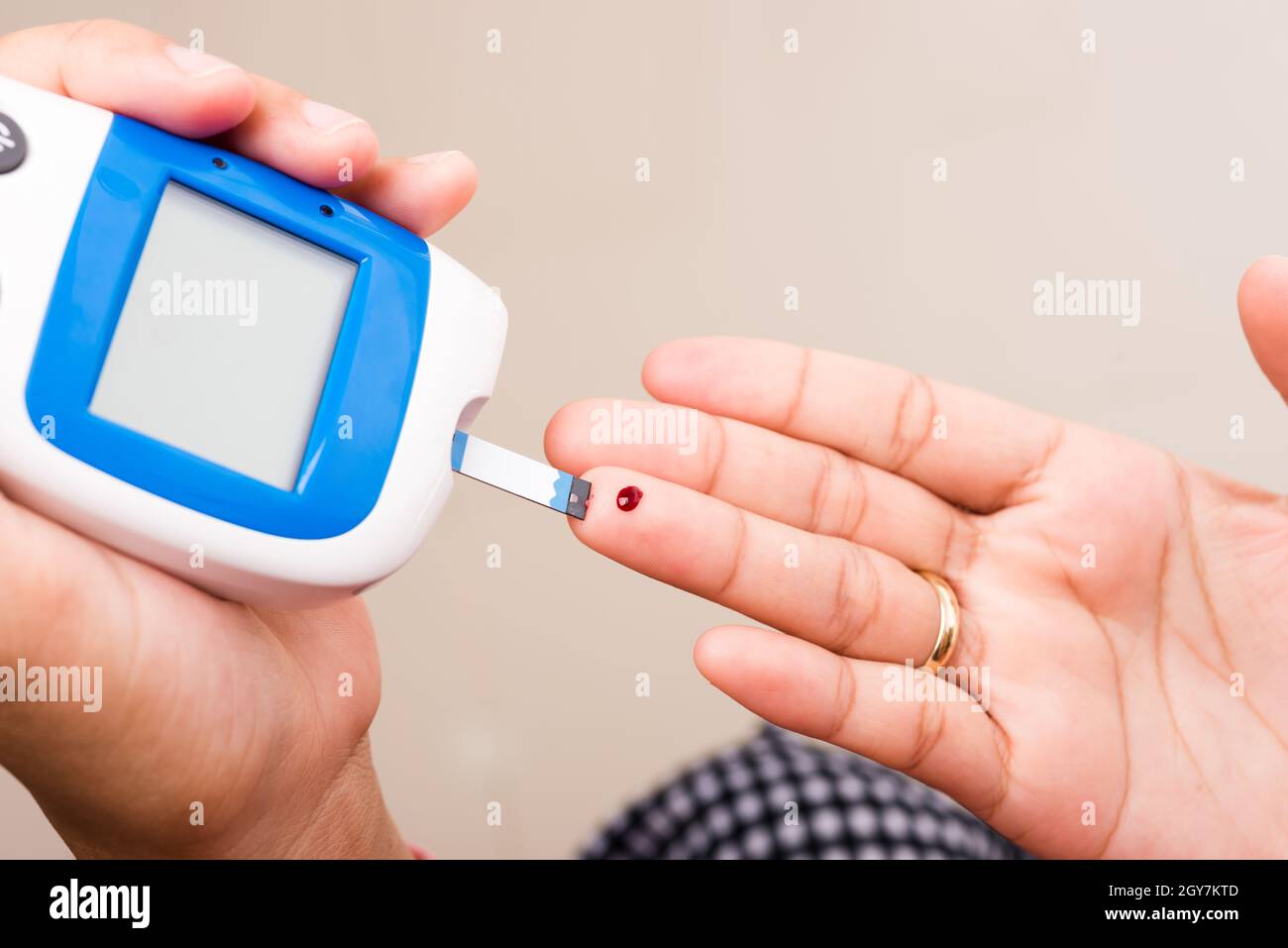 Closeup Hands woman measuring glucose test level check with blood on ...