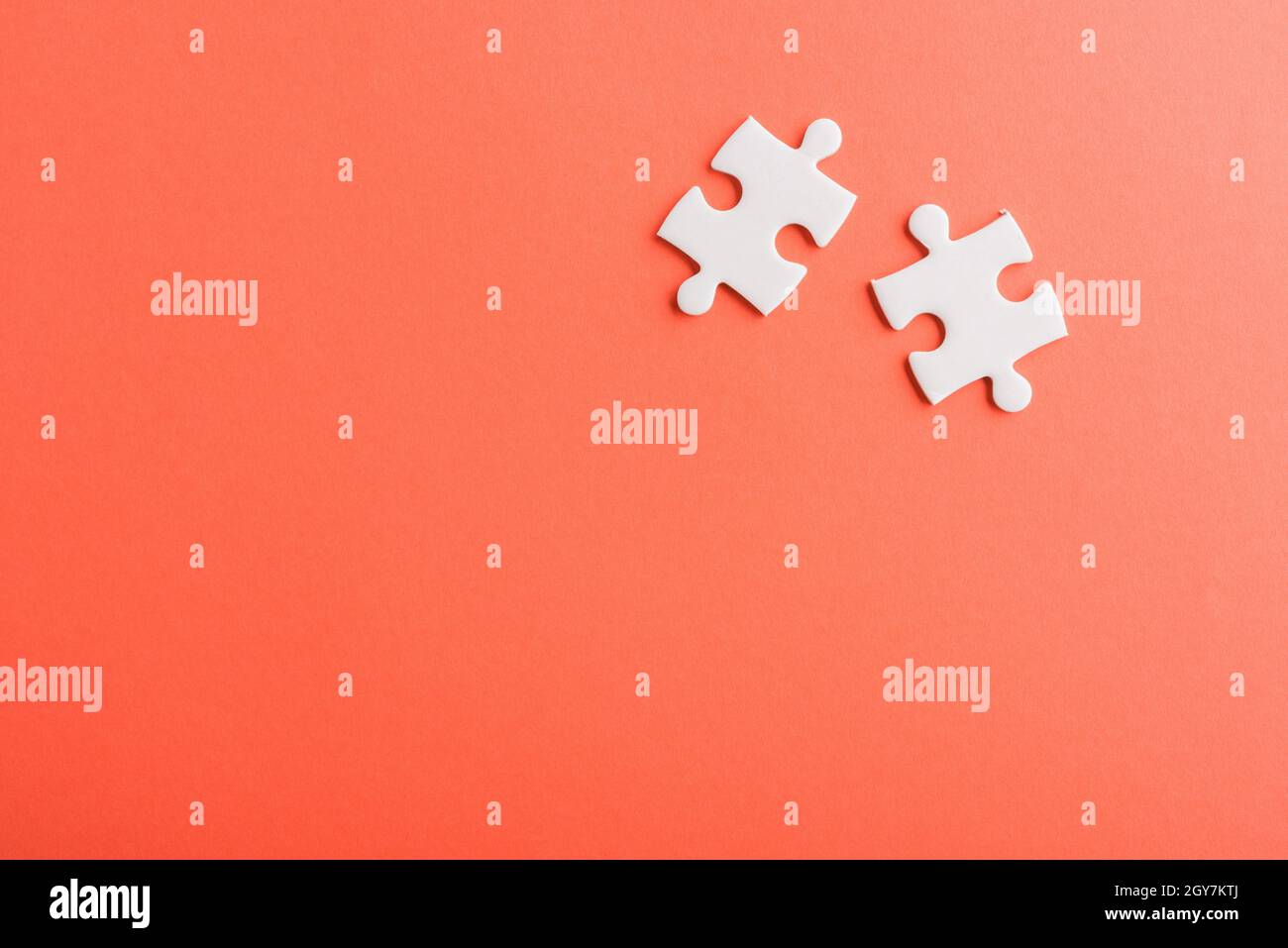 Top view flat lay of two paper plain white jigsaw puzzle game last ...