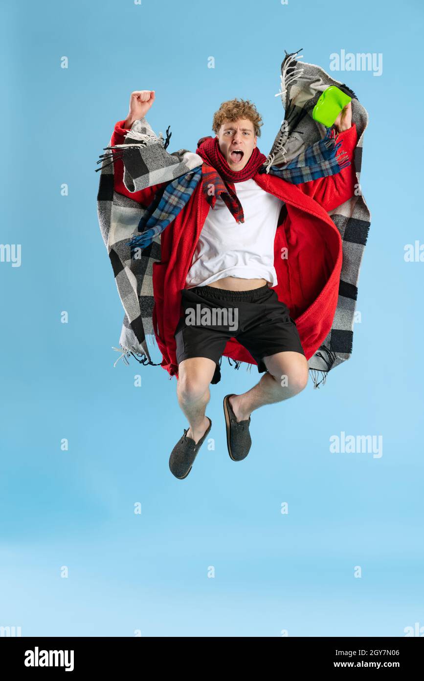 Full-length portrait of sick young boy, wearing plaid, robe and scarf ...