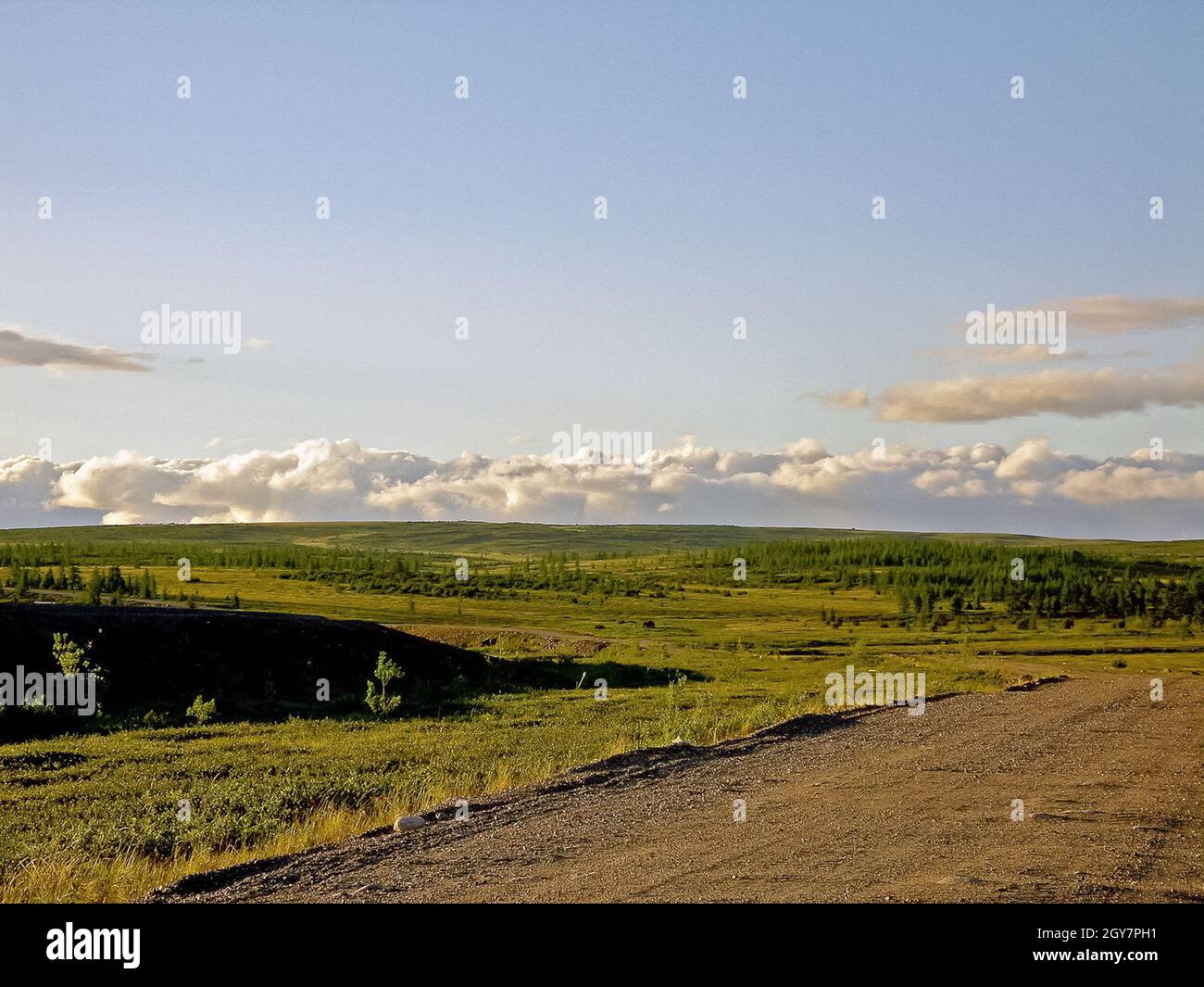A dirt road in the tundra in the summer. The road from the rubble mound ...