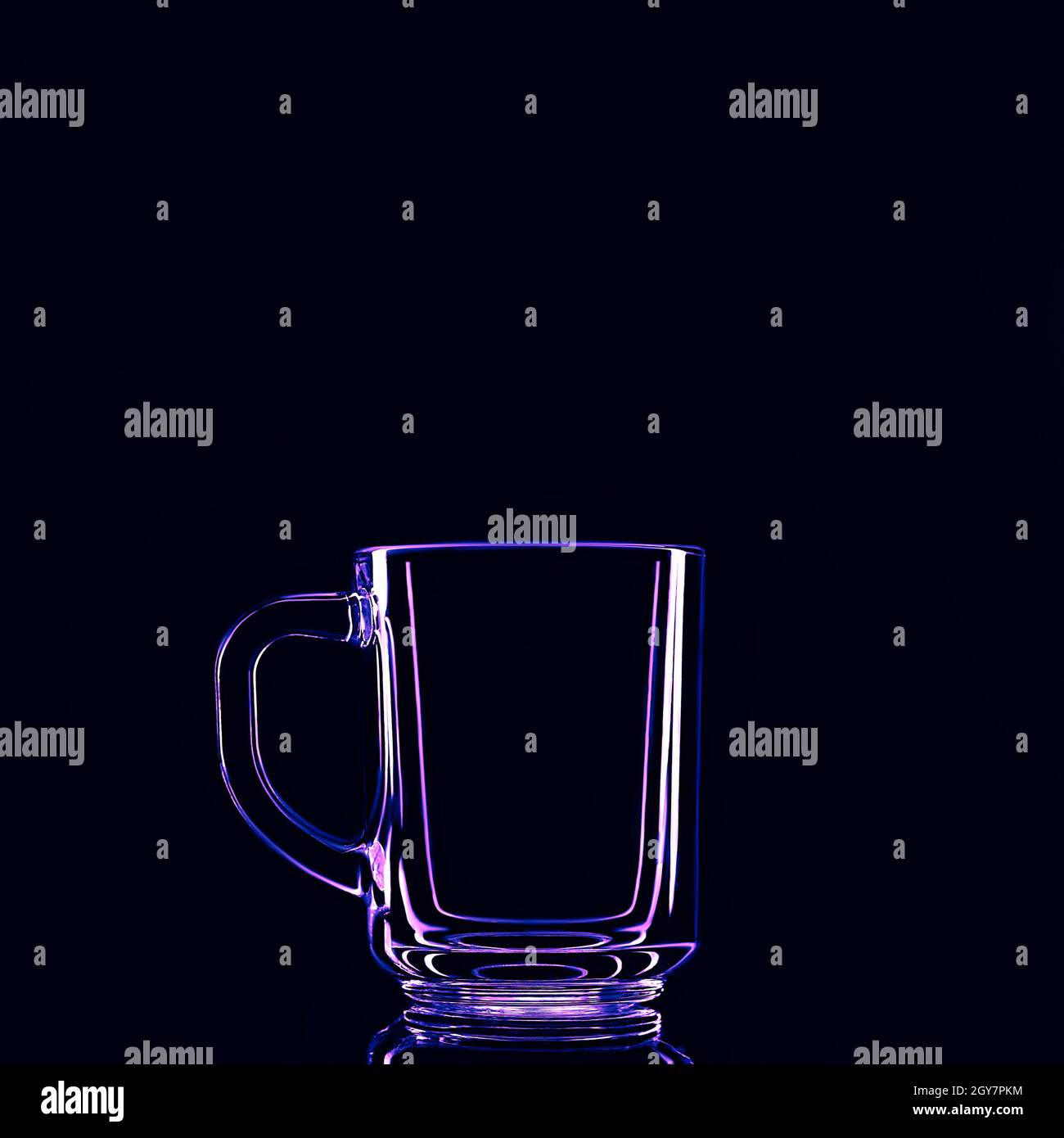 Just a glass on a black background with a reflection. Purple colors ...