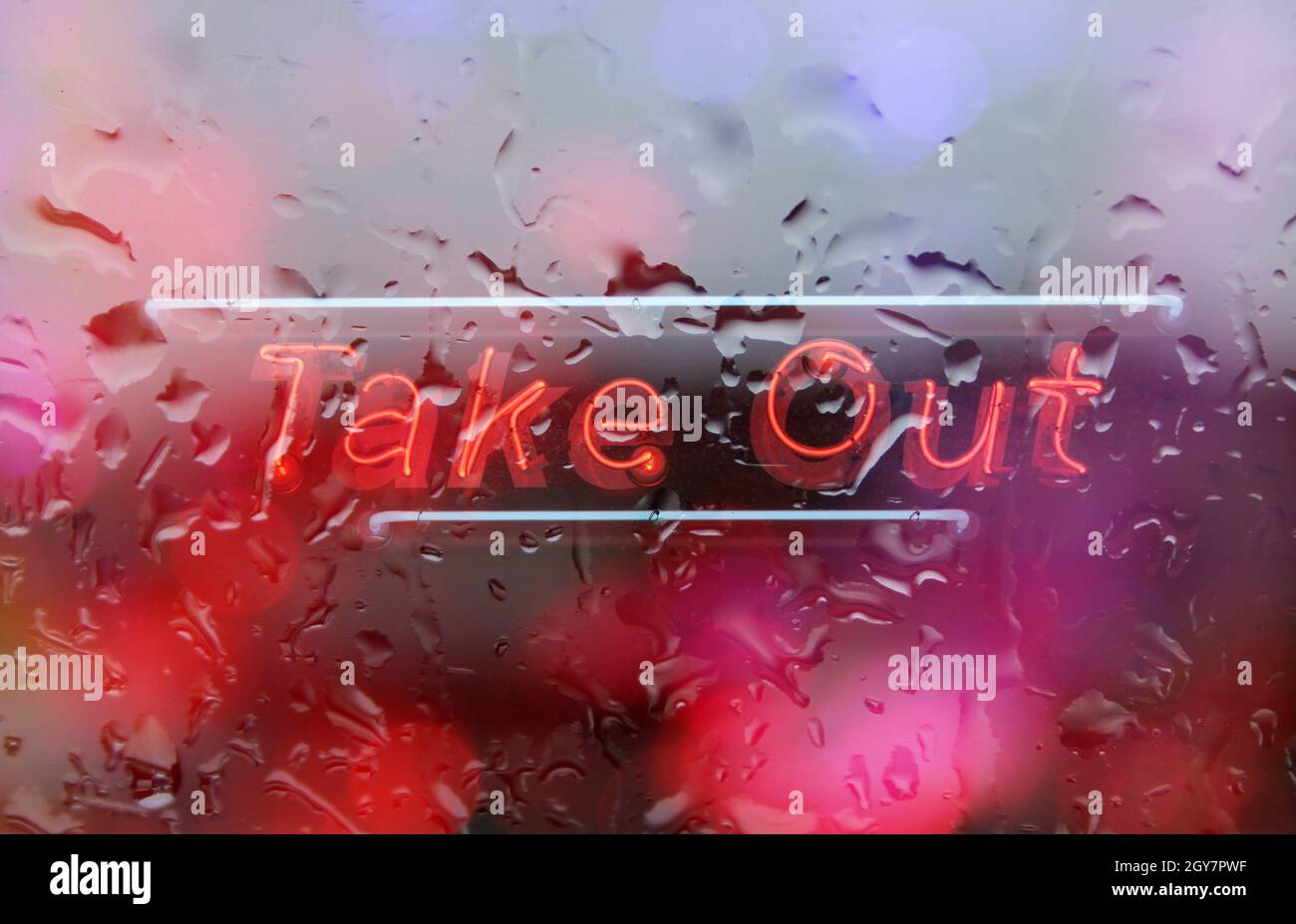Neon Take Out Sign in Wet Window Stock Photo - Alamy