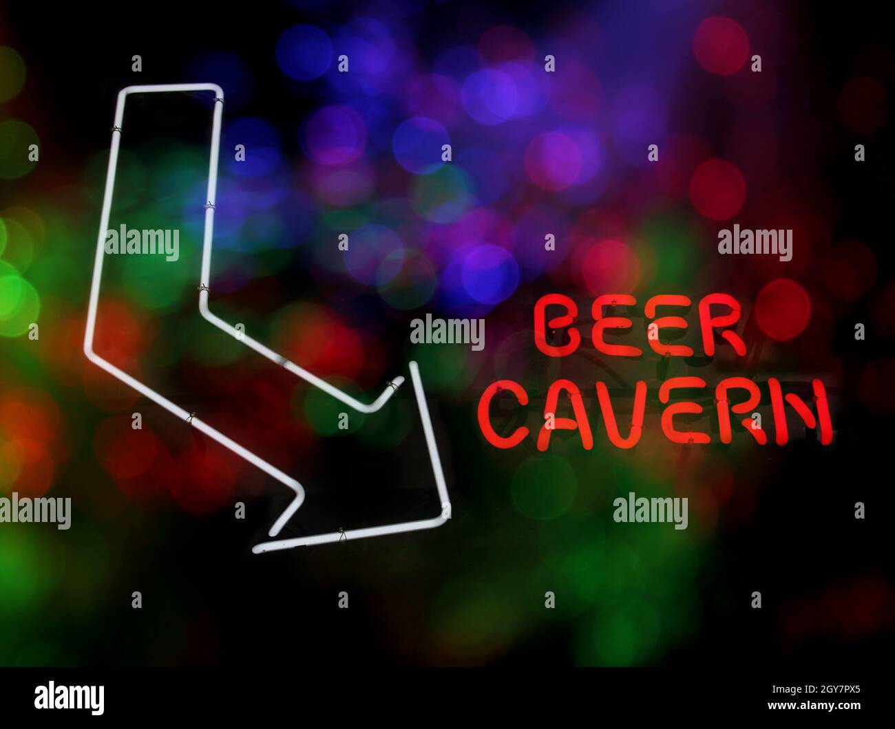 Neon Beer Cavern Sign With Arrow Stock Photo - Alamy