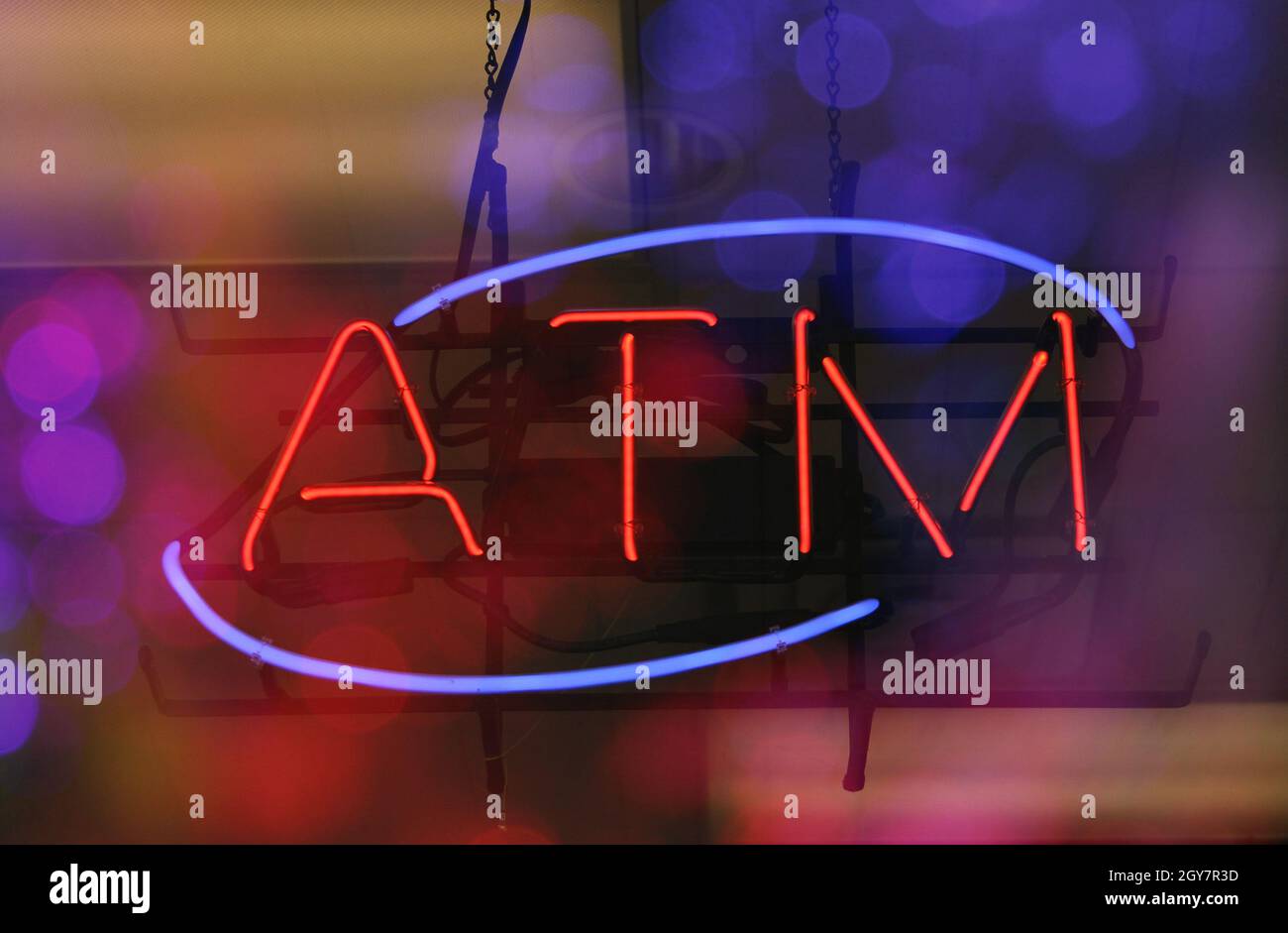 Neon Sign ATM in storefront window with Bokeh Stock Photo - Alamy