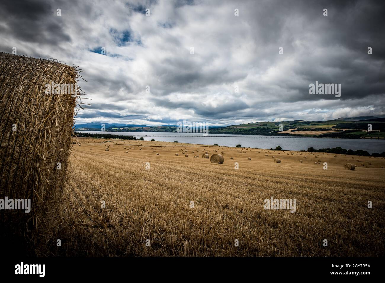Hay bales dotted across the nearly harvested fields overlooking ...