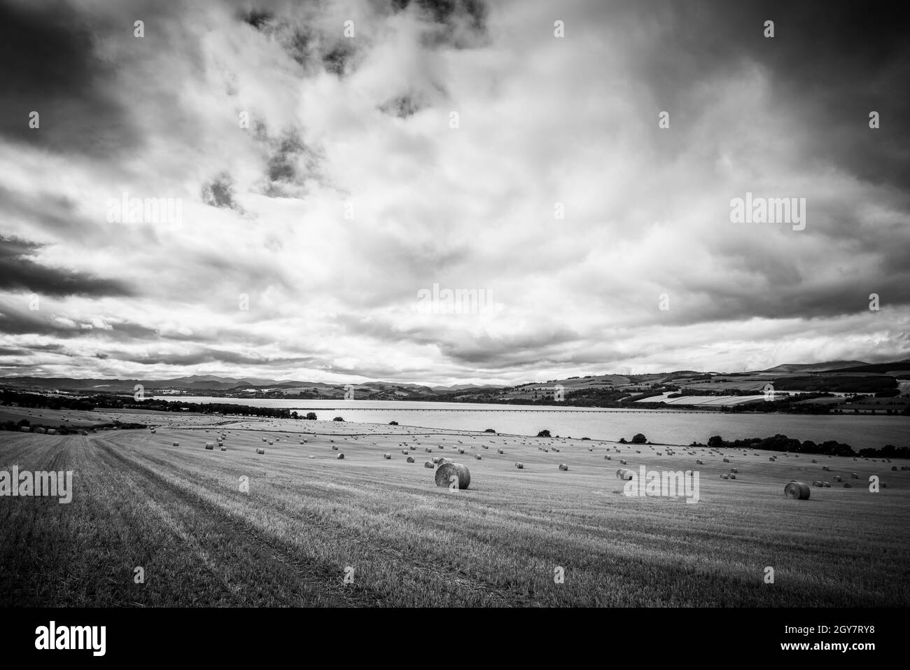 Hay bales dotted across the nearly harvested fields overlooking ...