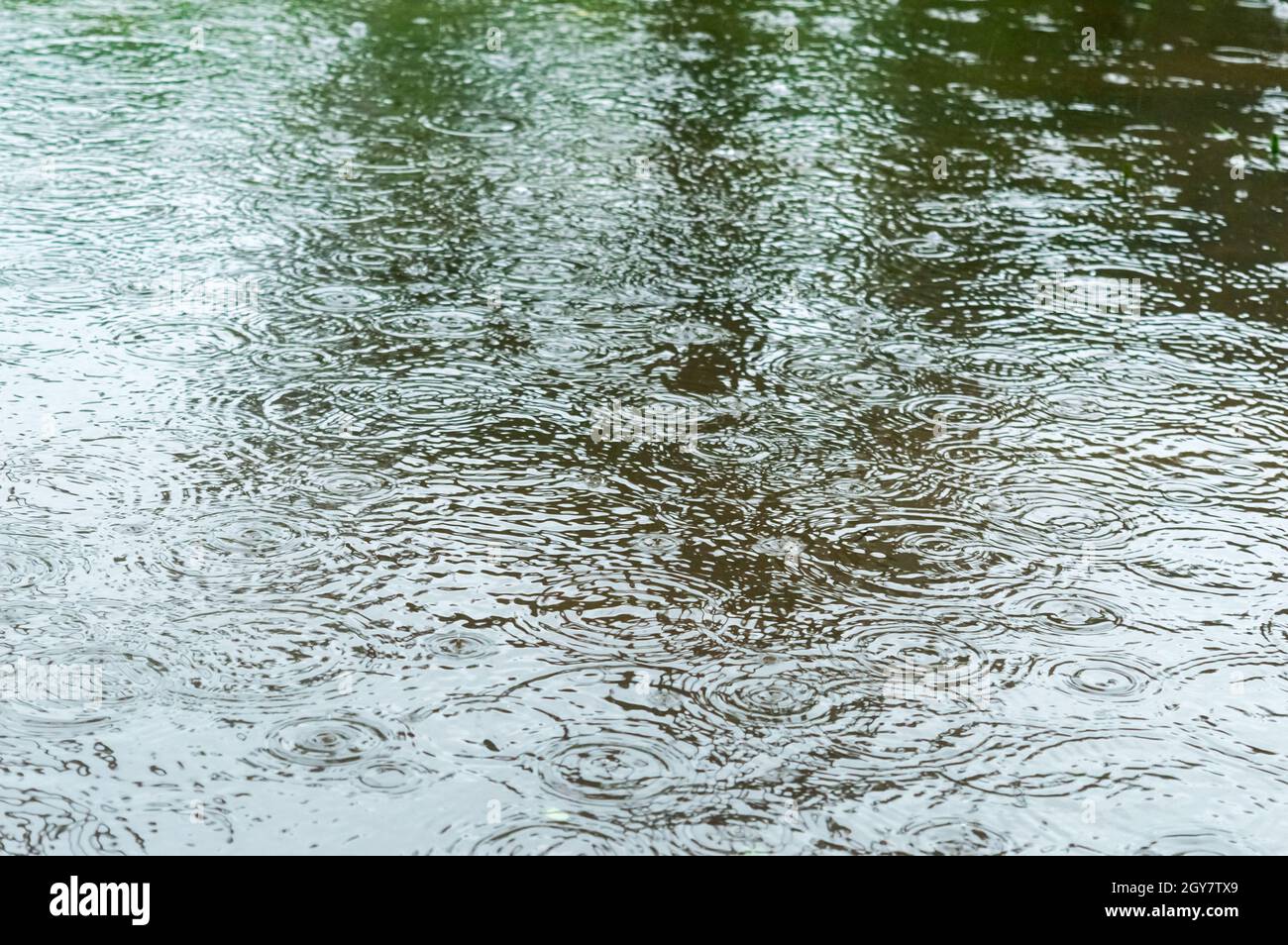 Raindrops falling on water. Rain Drops On water surface. Abstract ...