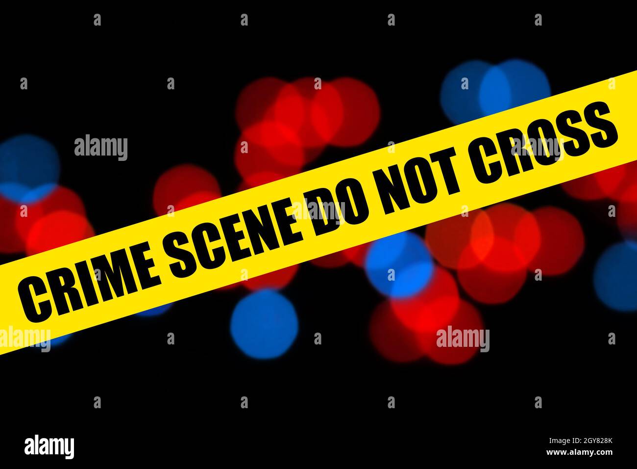 Close up yellow barricade tape with crime scene do not cross words over ...