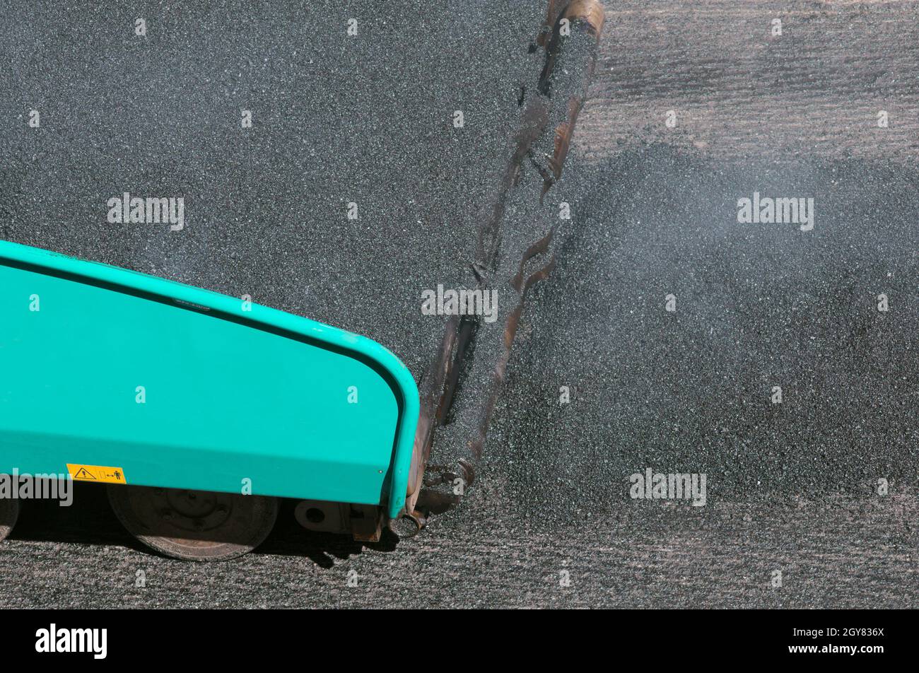 paving machine laying fresh tarmac Stock Photo - Alamy