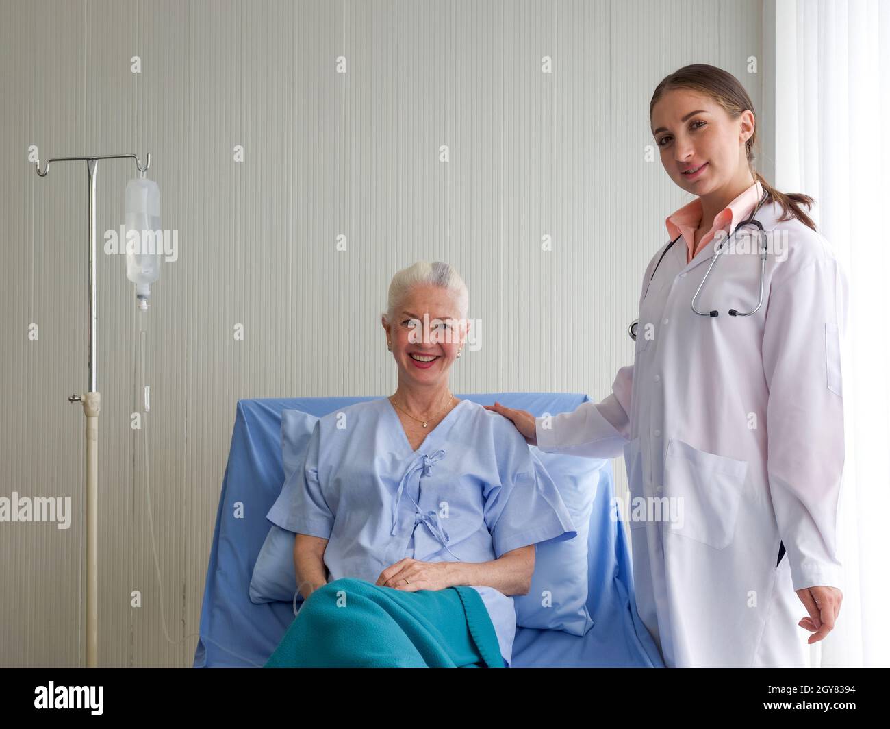 The Young doctor examine the symptom of the elderly patient in the ...